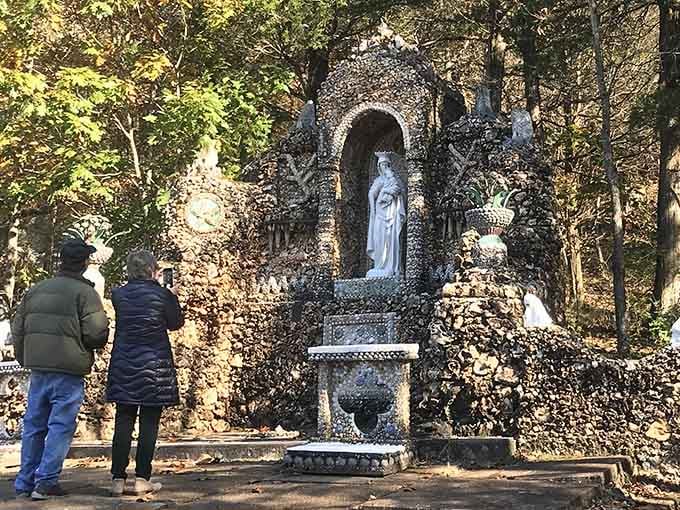 Visitors stand in awe before the grotto, experiencing that rare moment when expectations are completely exceeded.