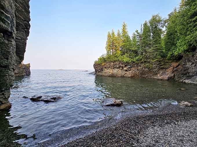The pebble beach nestled between the cliffs offers a front-row seat to Lake Superior's endless performance.
