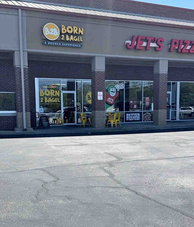 Strip mall exterior hiding breakfast gold, proving you can't judge a bagel shop by its parking lot.