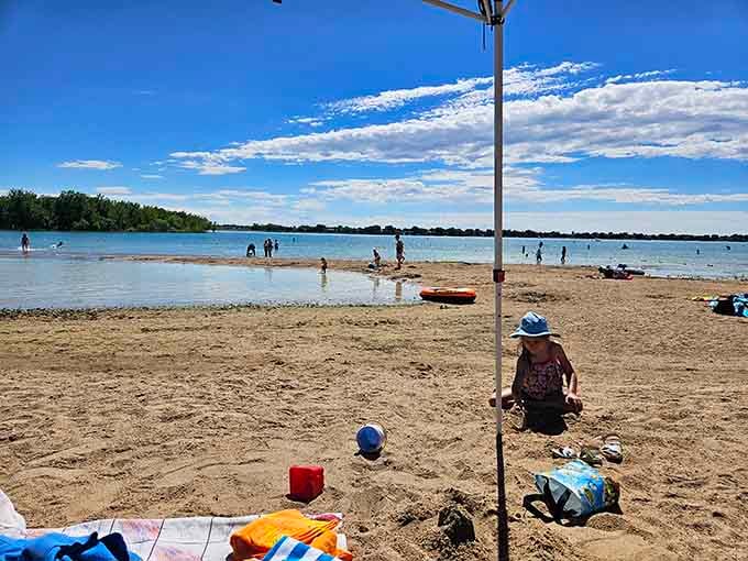 Beach umbrellas dot the sand while kids build castles, creating scenes that belong in coastal postcards.
