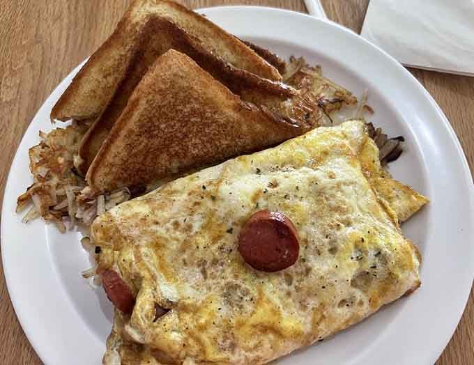 That omelet is stuffed with spicy sausage and comes with hash browns and toast, because moderation is overrated at breakfast.