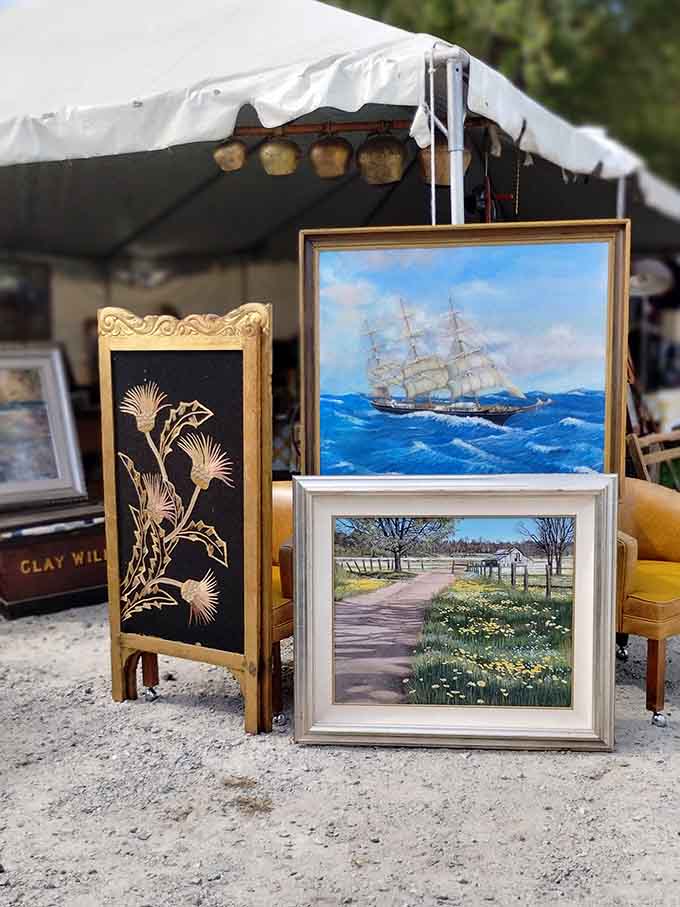Maritime paintings and folk art lean casually together, waiting for someone to give them new wall space.