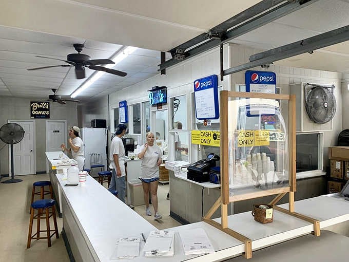 Behind the counter, the crew works with practiced efficiency, turning out batch after batch of golden perfection.