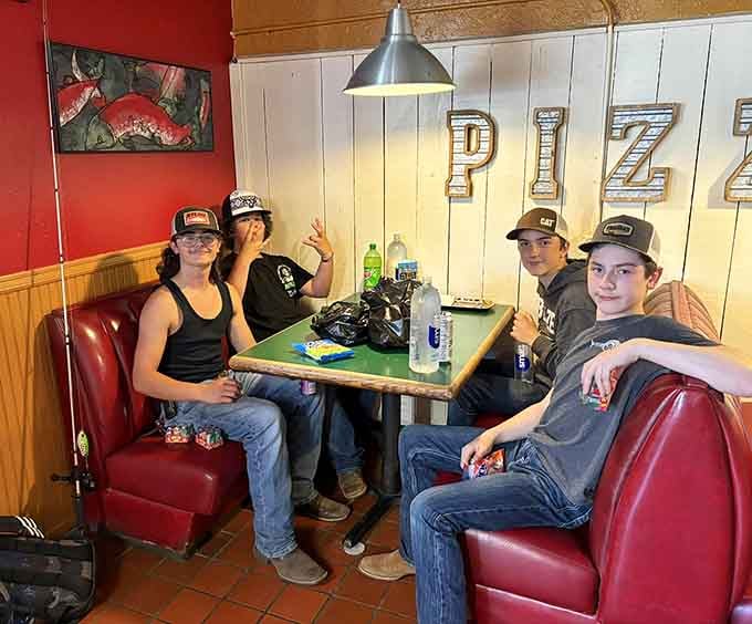 Happy diners settle into their booth, ready to tackle whatever enormous pizza creation they've bravely ordered for lunch.