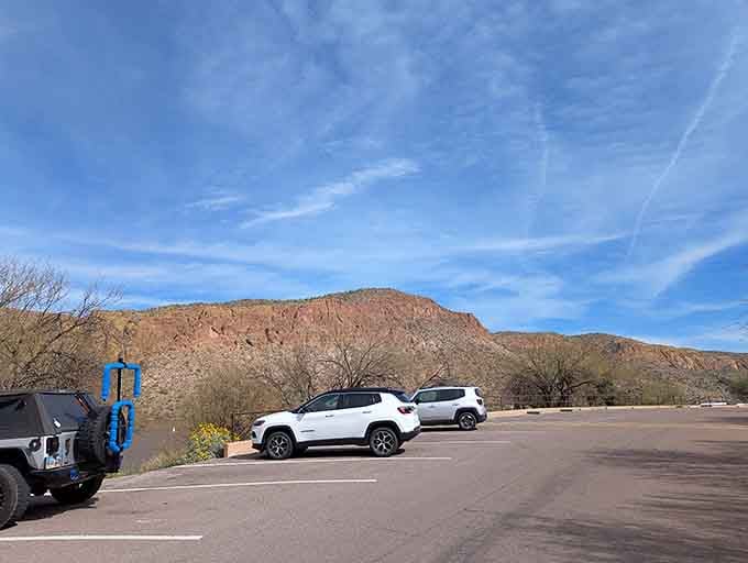 The parking area with those commanding cliff views in the background means your adventure starts before you even leave the car.