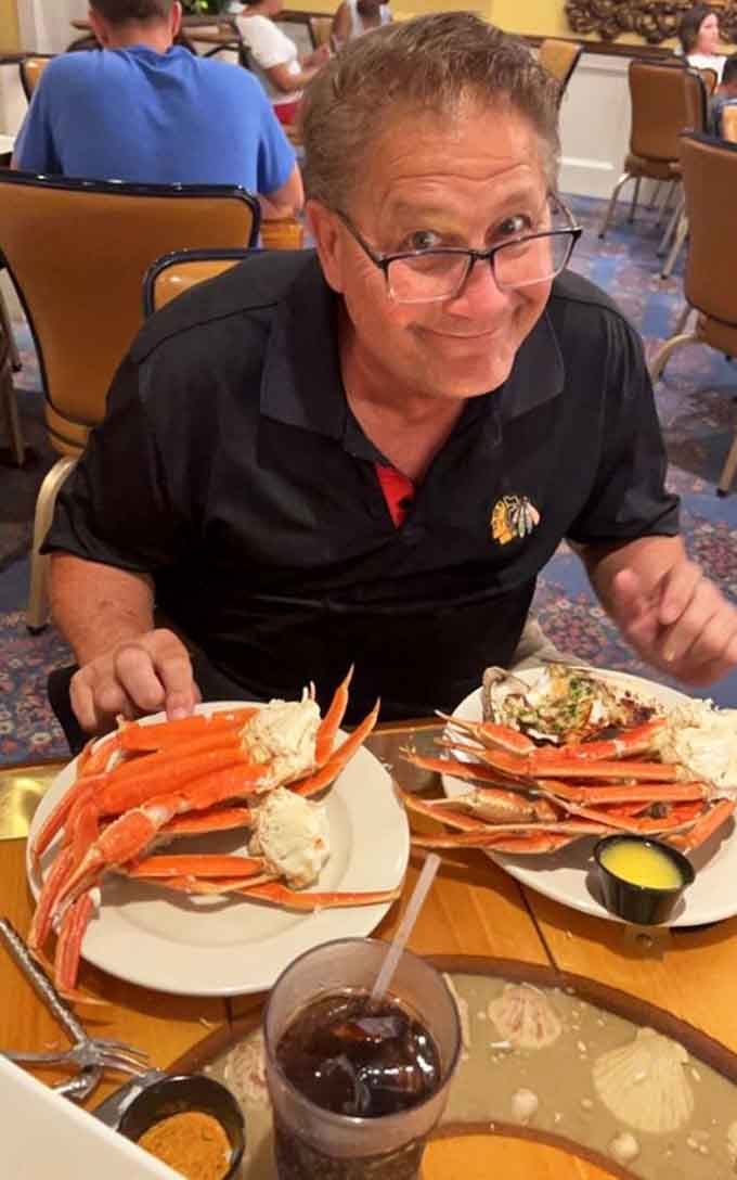Pure joy captured in one photo: a man, his crab legs, and unlimited trips to the buffet.