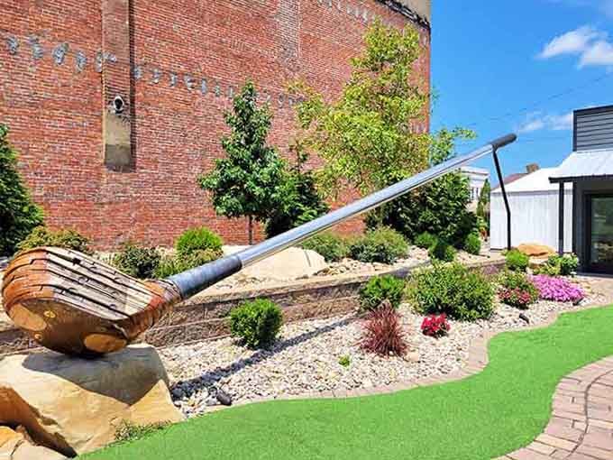 This enormous golf club leans casually against landscaping, ready for the world's most ambitious miniature golf course.