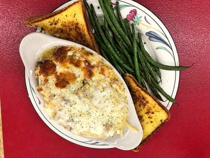 Golden lasagna with vibrant green beans shows Italian comfort food translates beautifully to the Pacific Northwest wilderness.