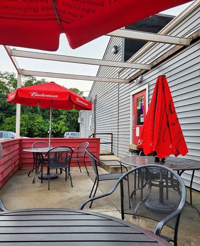 The outdoor patio offers fresh air dining under bright red umbrellas, perfect for those beautiful Ohio summer evenings.