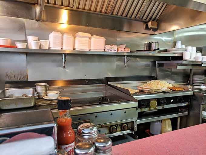 Stacks of plates ready for action and a well-seasoned griddle show a kitchen that means serious business daily.