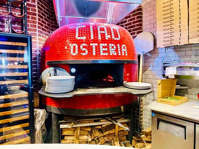 The wood-burning oven proudly displaying the restaurant's name, where pizza magic happens at temperatures that would terrify most home cooks.