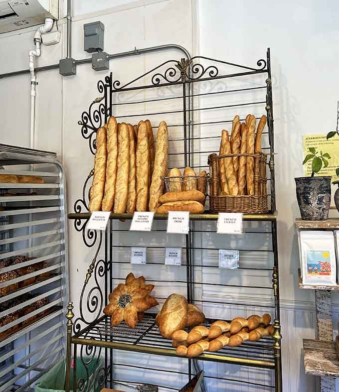 Baguettes standing at attention on their metal rack, ready to become someone's best meal today.