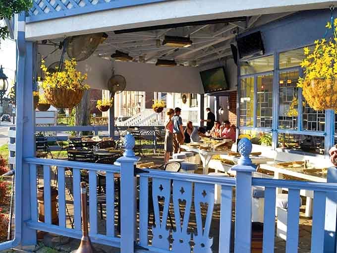 The charming outdoor space decorated with hanging flowers creates an inviting atmosphere for memorable meals.