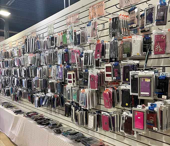 Phone protection in every color imaginable lines the pegboard, because even our devices deserve fashionable armor these days.