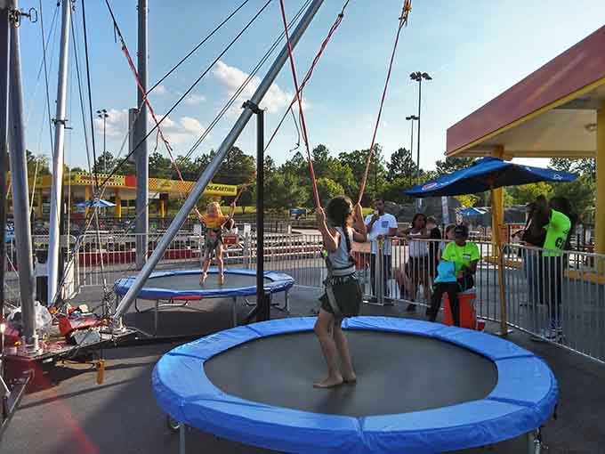 Kids bouncing skyward on trampolines while parents rest their feet is what shopping paradise looks like for families.