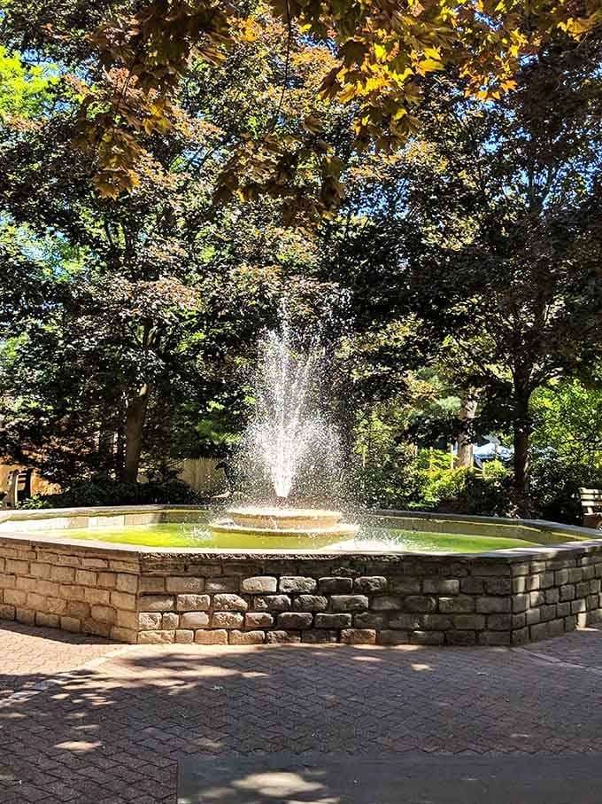 A fountain sparkles in dappled sunlight, offering the perfect spot to rest weary feet and souls.