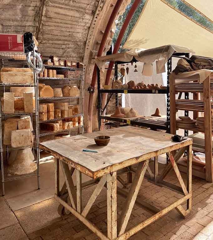 The pottery workshop area shows where clay becomes art, surrounded by shelves of works in progress.