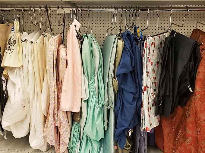 Linens and fabrics hang waiting for their next home, because everyone deserves soft things at reasonable prices.