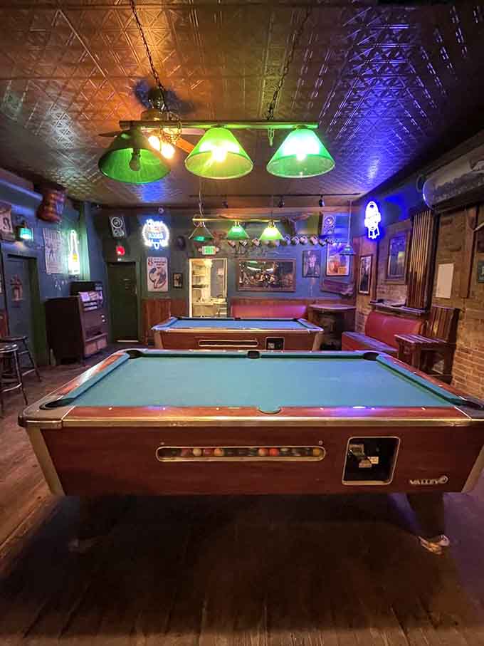 Pool tables under green lamps, because every proper saloon needs entertainment beyond just excellent food service.