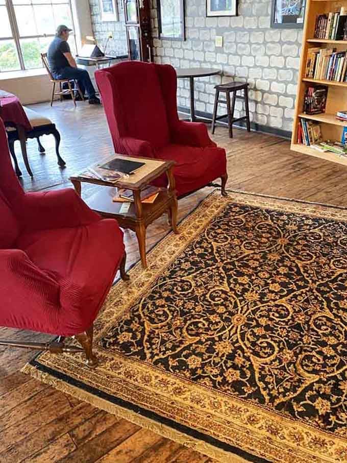 Red velvet chairs and Persian rugs transform a simple cafe into a reading room worthy of any fantasy novel.