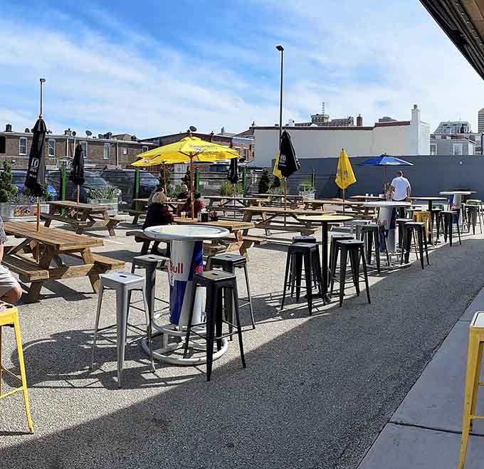 Picnic tables under yellow umbrellas transform a parking lot into prime real estate for enjoying cold drinks and Atlantic City's surprisingly pleasant weather.