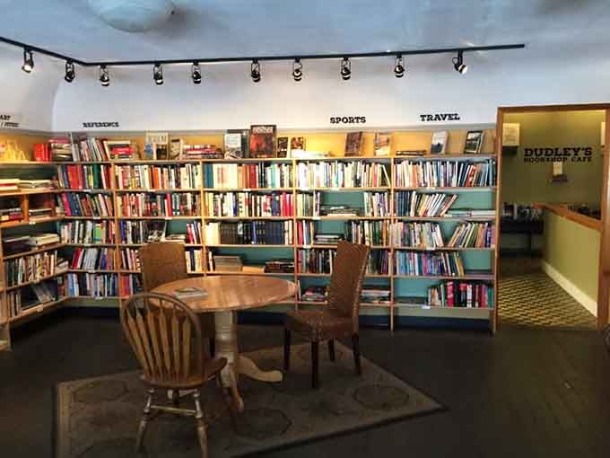 Round wooden table surrounded by mismatched chairs invites lingering conversations over coffee and compelling chapters.