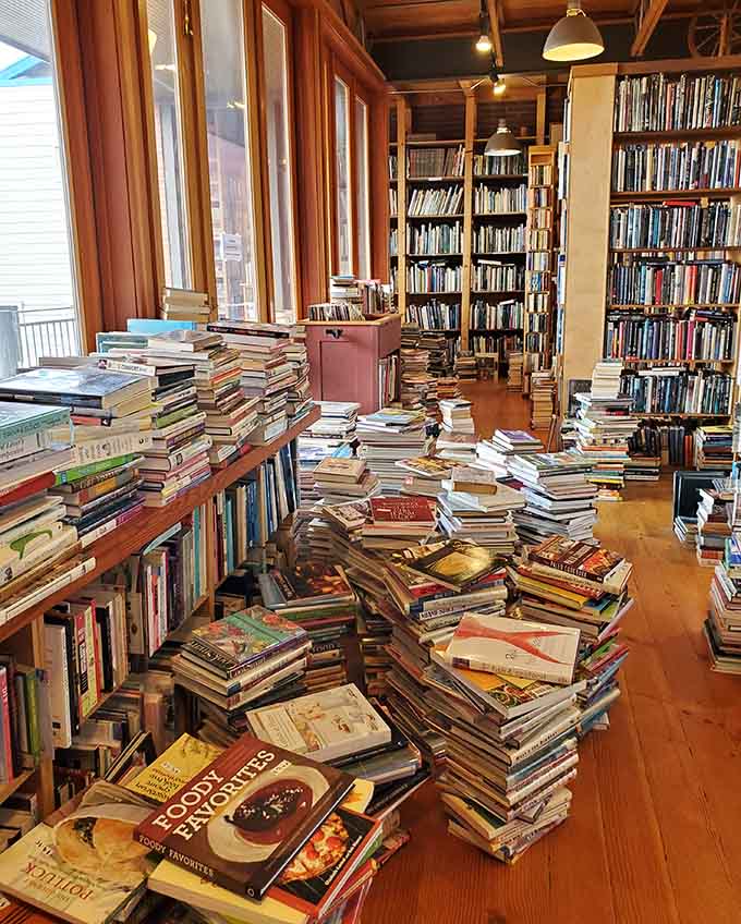 Piles of books sprawl across tables like they're staging a peaceful protest against digital reading devices.