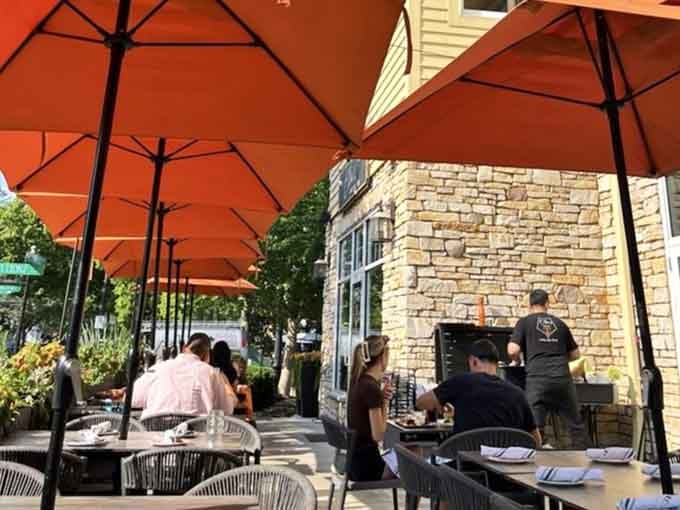 Outdoor dining under those vibrant umbrellas turns a regular meal into a mini European vacation experience.