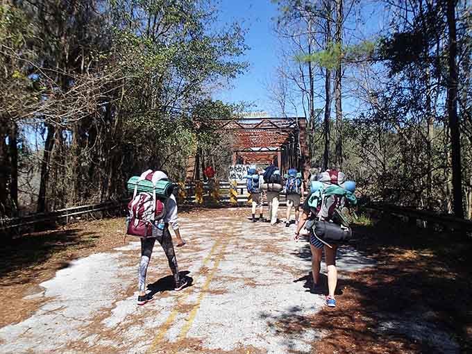 Modern backpackers traverse the same paths where Ellaville residents once walked, connecting past and present with every step taken.