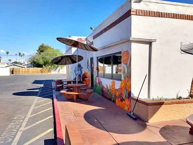 Outdoor seating with colorful murals and terracotta tables&mdash;perfect for enjoying tacos under the Arizona sky.