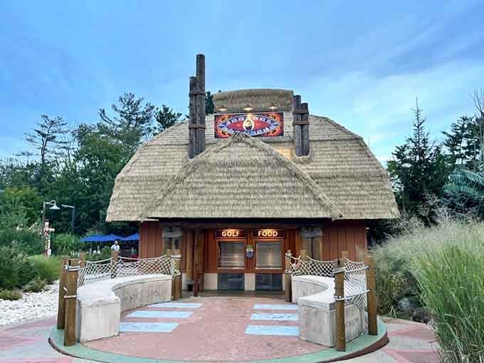 That thatched-roof hut houses the essentials: golf equipment distribution and snacks for weary travelers seeking sustenance.