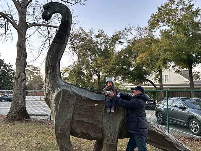 This dinosaur statue has probably posed for more family photos than most professional models ever will.