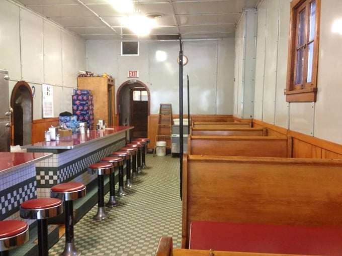 Wooden booths offer a quieter alternative to counter seating, though you'll miss watching the griddle magic happen up close.