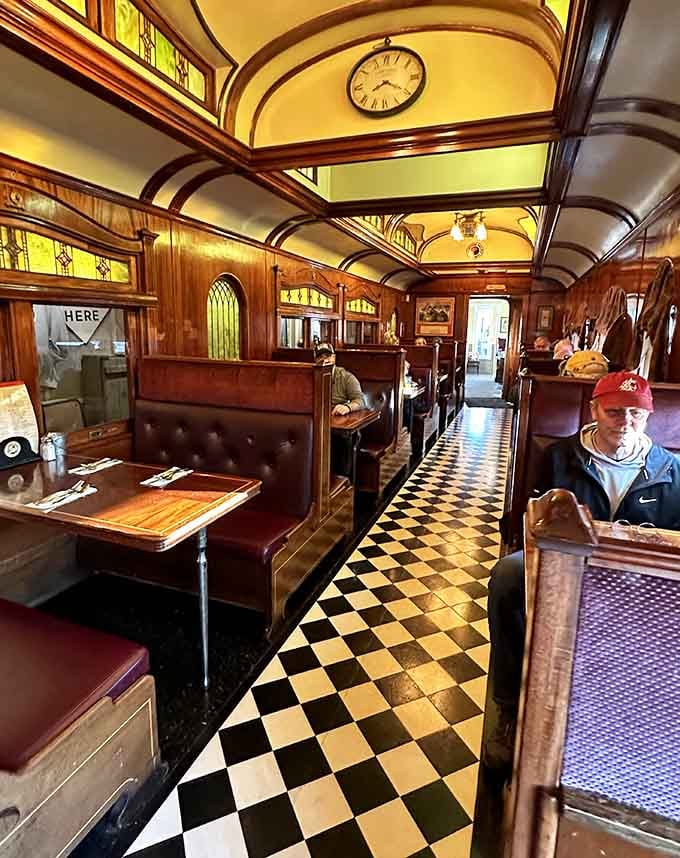 Looking down that checkered aisle with mahogany booths lining both sides feels like stepping into another era entirely.