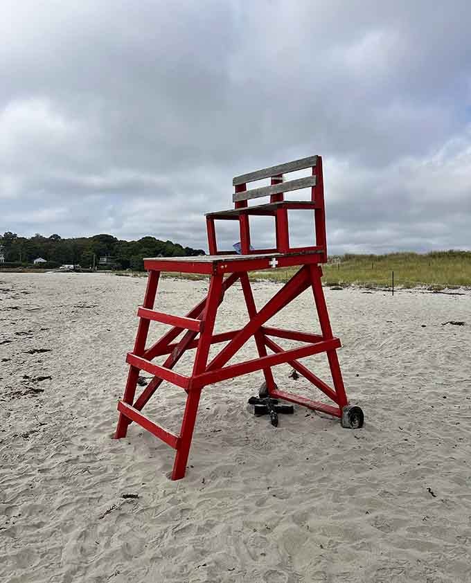 The iconic red lifeguard chair stands ready for duty, a beacon of safety that's been watching over swimmers since your kids were kids.