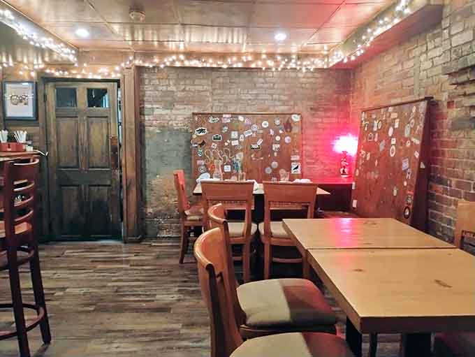 Weathered doors and exposed brick bathed in rosy light give this dining space character that new construction simply cannot buy.