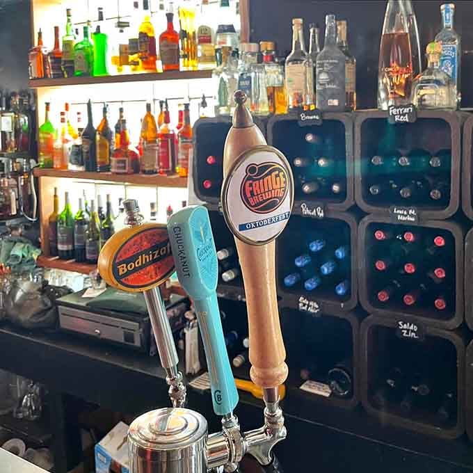 German beer taps standing proud among the bottles signal authentic Old World hospitality awaits your order.