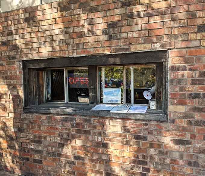 That order window framed in weathered brick has been serving up happiness one burger at a time for decades.
