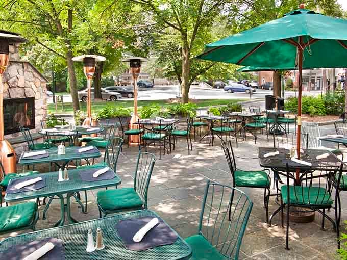 Outdoor seating under the trees, where warm-weather meals become even more memorable and delightful.