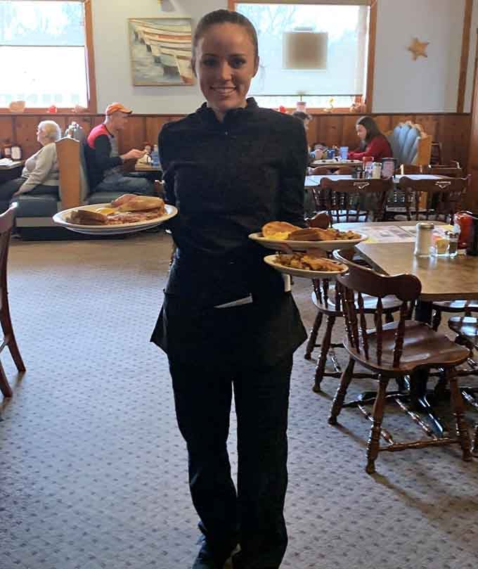Friendly staff delivering plates piled high with food, smiling because they know exactly how good everything tastes here.