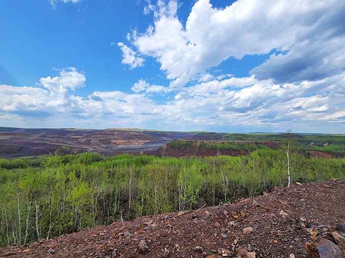 The rocky overlook where you can actually watch history being made, one enormous truckload of ore at a time.