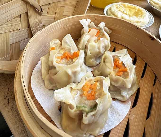 Steamed dumplings in a bamboo basket, proving this country store has more culinary tricks up its sleeve than you expected.