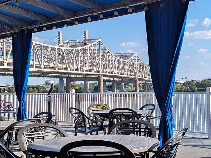 Blue curtains framing bridge views on the patio create an outdoor dining room that rivals any coastal resort.