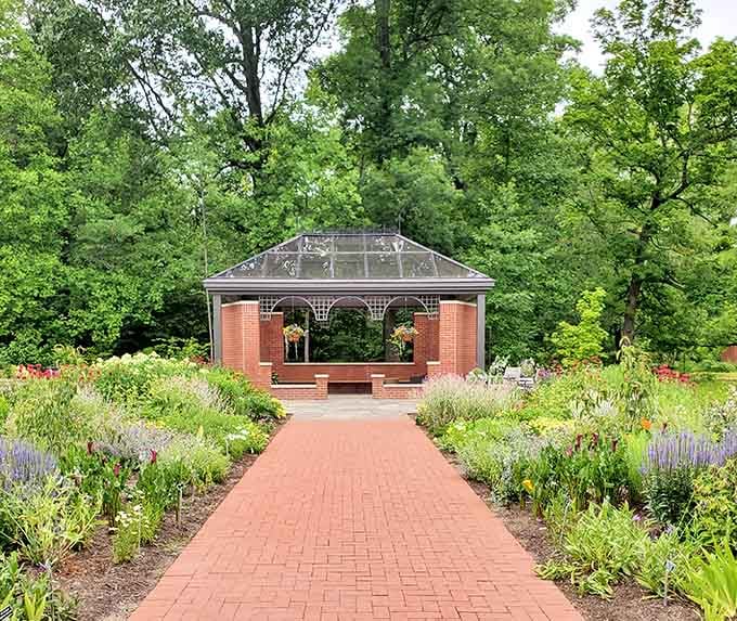 The brick pavilion provides shelter and seating where visitors can rest while surrounded by perennials and possibilities.