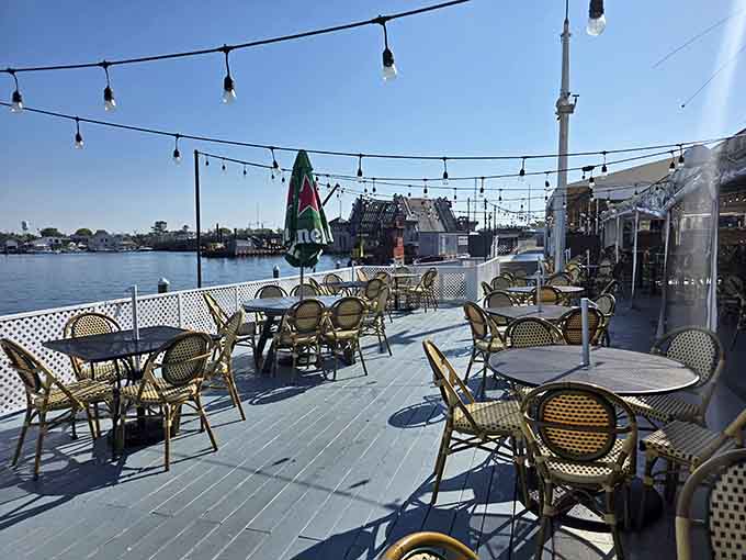The expansive deck stretches over the water where string lights and river breezes conspire to create magical dining moments.