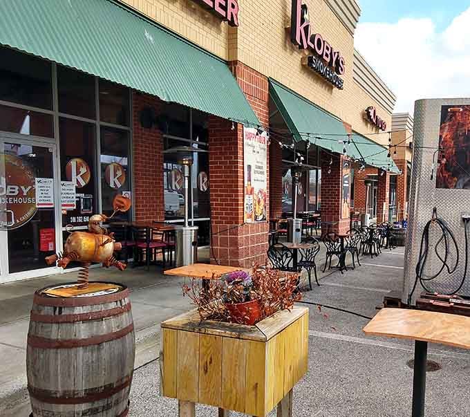 Outdoor seating with whiskey barrels as tables, because sometimes you need fresh air with your smoked meat and bourbon.