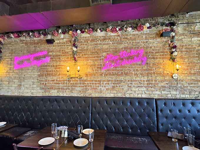 Neon signs and exposed brick walls prove that Instagram-worthy decor can coexist with serious food in perfect harmony.