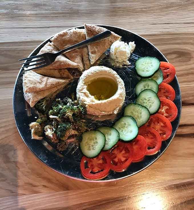 Mediterranean flavors assembled into a hummus plate that offers a lighter alternative before the pizza arrives.
