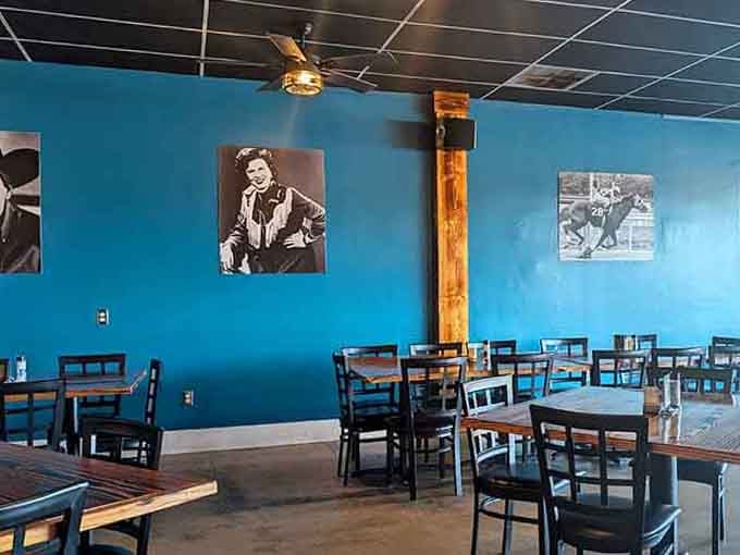 Classic portraits on vibrant blue walls create an atmosphere that's both nostalgic and refreshingly modern at once.
