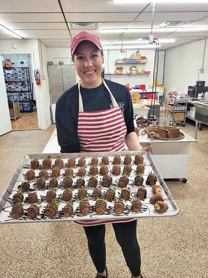 Behind every great candy selection stands someone who clearly loves their job and those chocolate-covered strawberries.